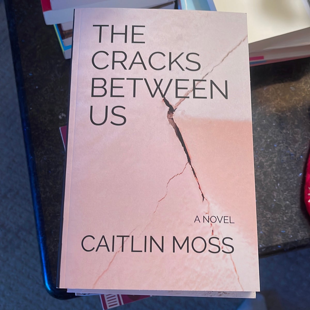 The Cracks Between Us by Caitlin Moss