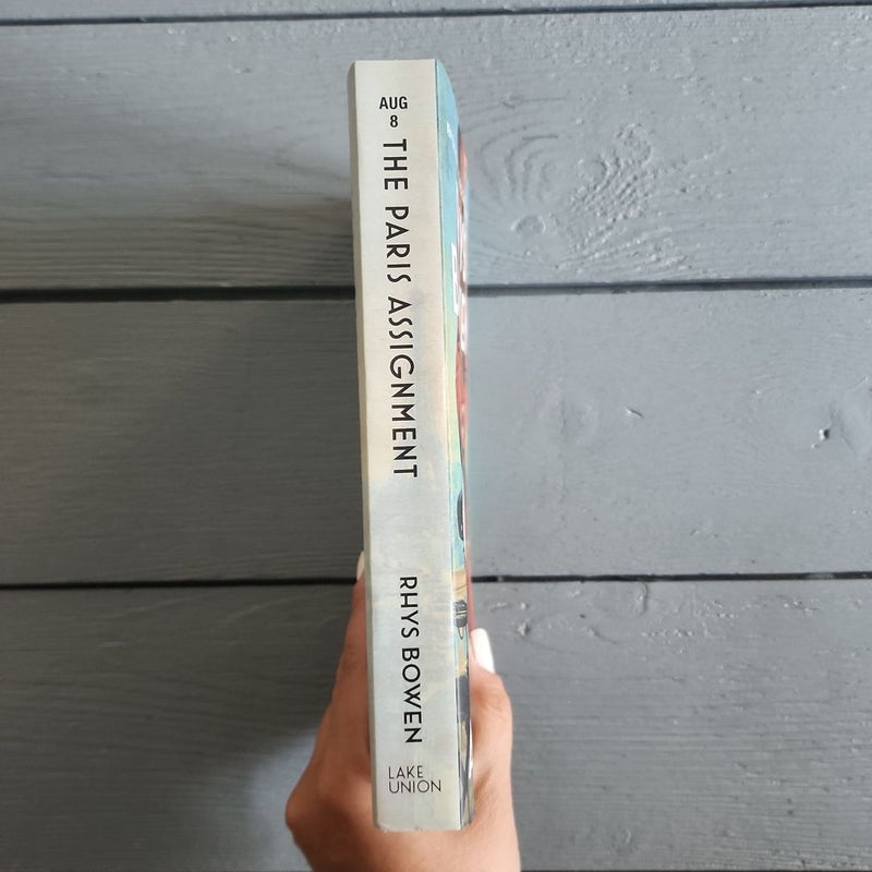 The Paris Assignment ARC by Rhys Bowen, Paperback | Pangobooks