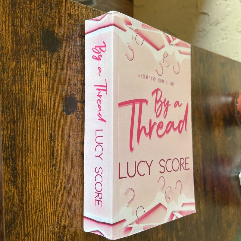 By a thread by Lucy Score, Paperback | Pangobooks