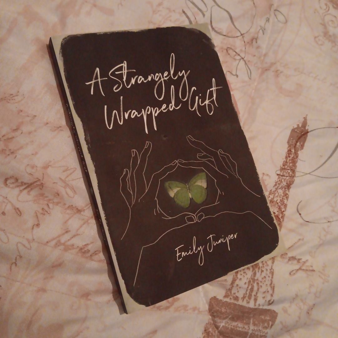 A Strangely Wrapped Gift by Emily Juniper, Paperback | Pangobooks