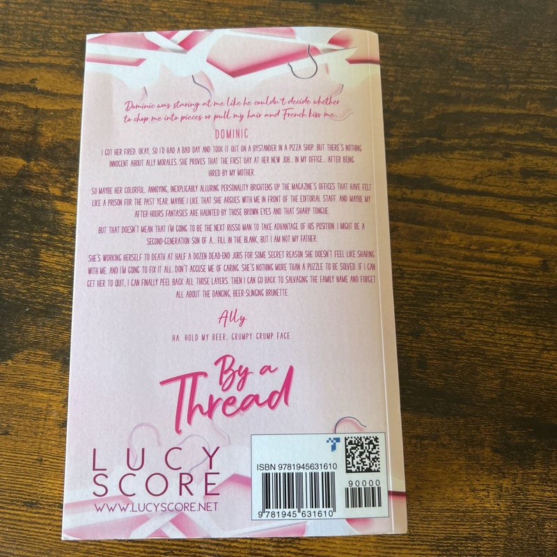 By a thread by Lucy Score, Paperback | Pangobooks