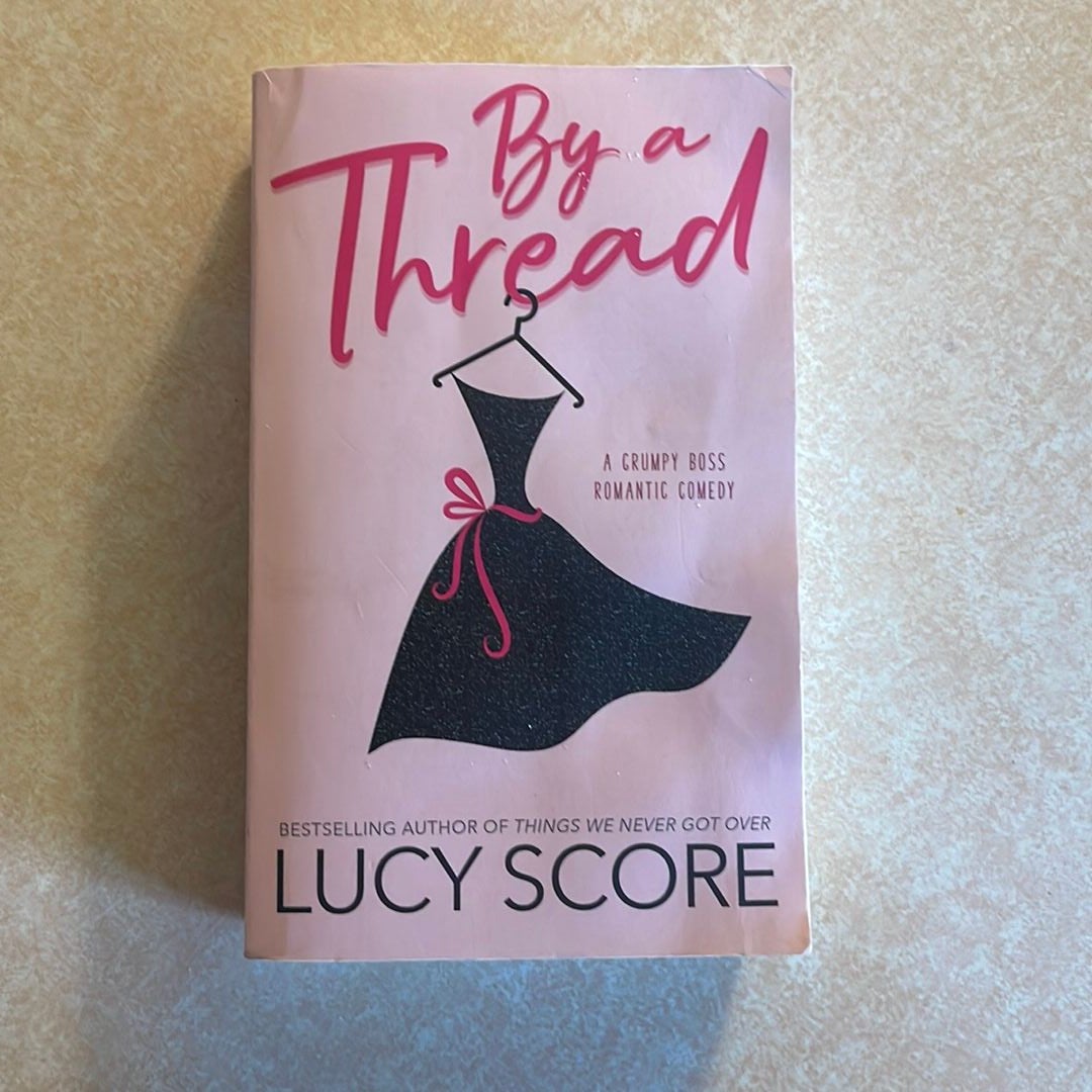 By a Thread by Lucy Score, Paperback | Pangobooks