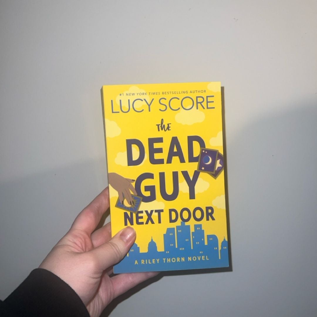 the dead guy next door by lucy score, Paperback | Pangobooks