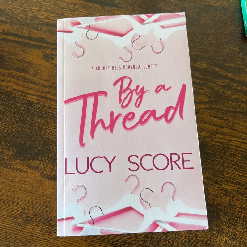 By a thread by Lucy Score, Paperback | Pangobooks